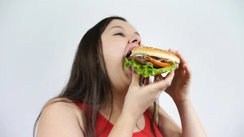 Obese women are happy with eating hambur... | Stock Video | Pond5
