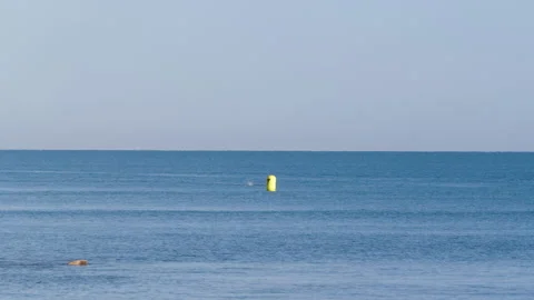 Ocean Swimmer Swimming Around Yellow Buo... | Stock Video | Pond5