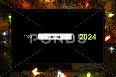 Photograph: Office desk with 2024 loading bar on laptop screen on ...