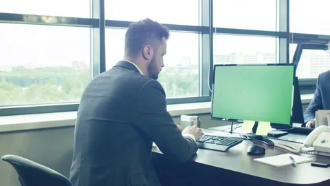 Office worker behind monitor with a gree... | Stock Video | Pond5
