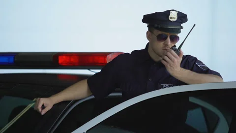 Officer getting out from car and informi... | Stock Video | Pond5
