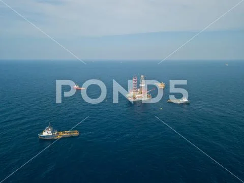 Offshore jack up rig and tow vessels during the rig move operation at the off Stock Image #146010956