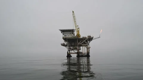 Offshore oil rig burning off gas on calm... | Stock Video | Pond5