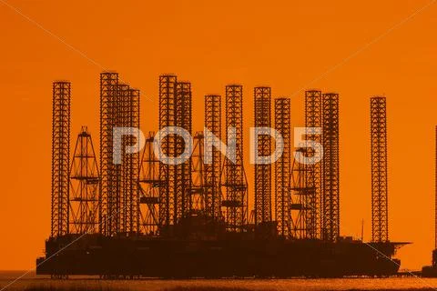 Offshore oil rig at shallow waters during sunset Stock Photo #36125055