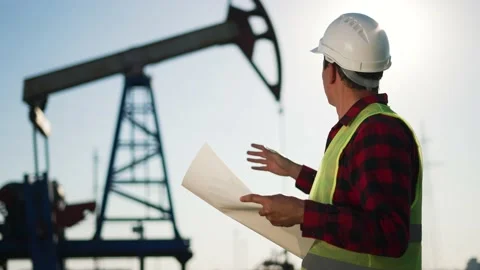 Oil industry. Engineer worker makes note... | Stock Video | Pond5