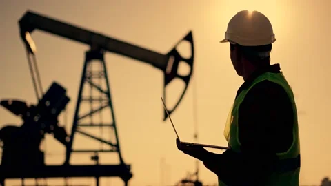 Oil pump.Engineer work with laptop and d... | Stock Video | Pond5