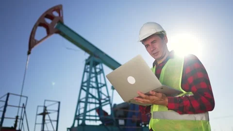 Oil pump.Engineer work with laptop and d... | Stock Video | Pond5