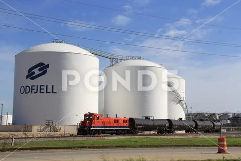 Oil Tanker Train next to very large oil Storage Tanks Stock Photo ...