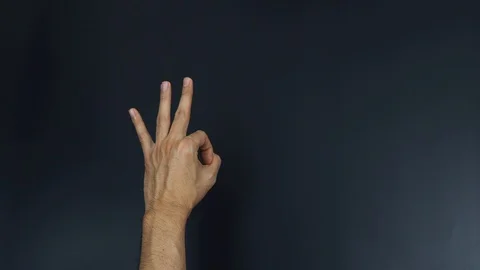 Ok hand sign on black background | Stock Video | Pond5