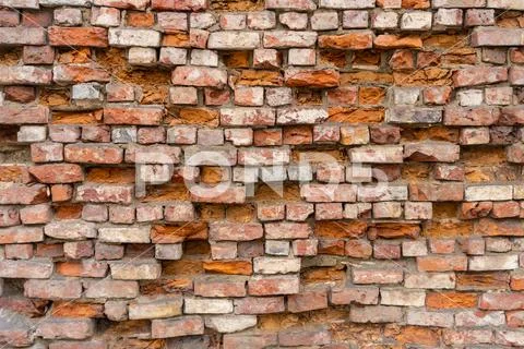 Old and damaged brick wall background with dropped out bricks. Stock ...