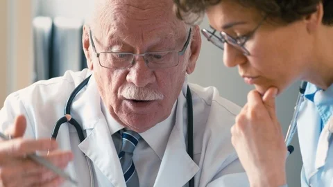 Old and young doctors discussing medical... | Stock Video | Pond5
