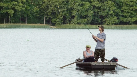 Old angler with a grandson sitting in th... | Stock Video | Pond5