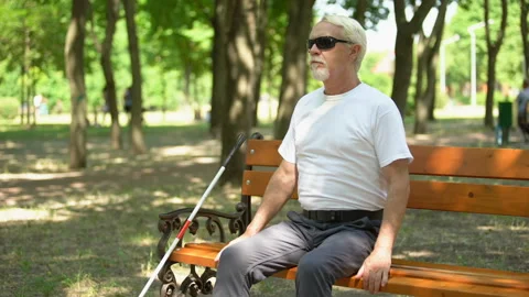 Old blind man finding long cane on bench... | Stock Video | Pond5