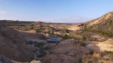 Old car driving alone on a road in a des... | Stock Video | Pond5
