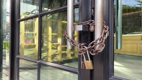 Old chain and gold locker on closed door... | Stock Video | Pond5
