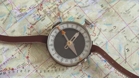 Old compass on map with mountain trails.... | Stock Video | Pond5
