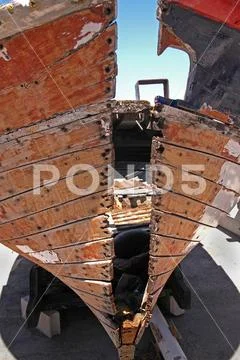 Old destroyed wooden colored fishing boat under repair. Saint Tropez ...