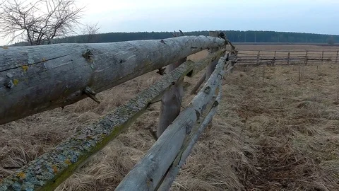 Old fence in the field in early spring | Stock Video | Pond5