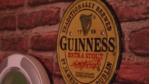 Old Guinness sign logo on wall of tradit... | Stock Video | Pond5