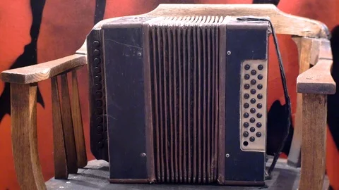 An old harmonica stands on a chair. | Stock Video | Pond5