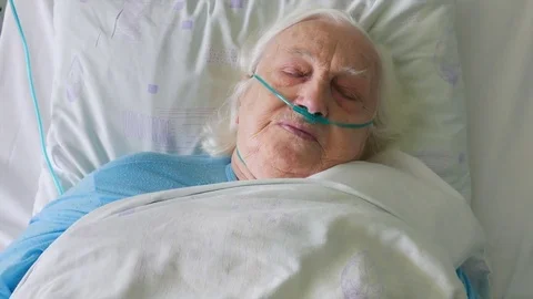 Old, ill woman in hospital bed | Stock Video | Pond5