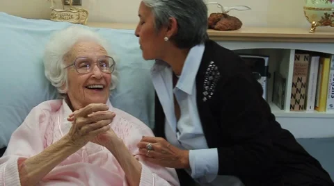 Old lady in death bed happily gives ring... | Stock Video | Pond5