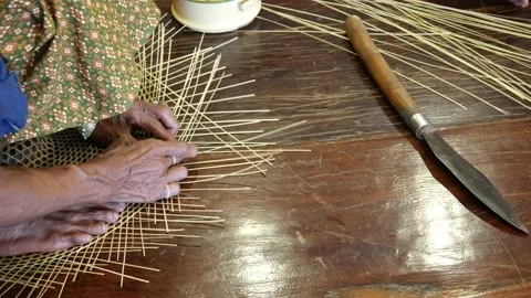 An old lady weaving handmade craft | Stock Video | Pond5