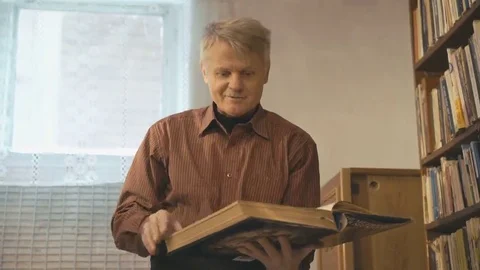 The old man flipping through the book in... | Stock Video | Pond5