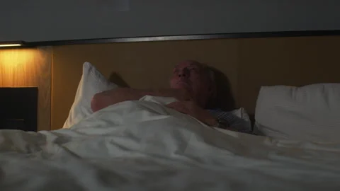 Old man laying in his bed | Stock Video | Pond5