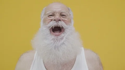 Old man with a long beard on a yellow ba... | Stock Video | Pond5