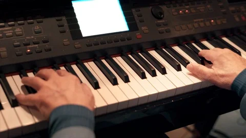 Old man playing keyboard | Stock Video | Pond5