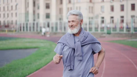 Old man run in sport stadium. Grandpa jo... | Stock Video | Pond5