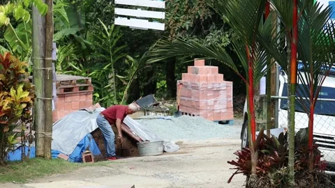 Old man shoveling the ground and putting... | Stock Video | Pond5