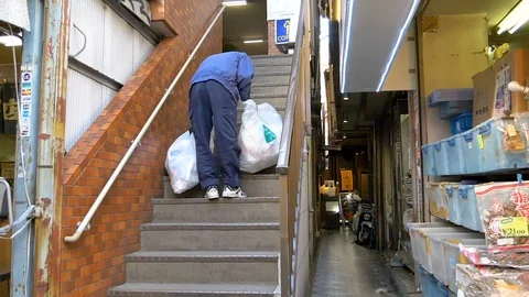 An old man slowly moving down the stairs... | Stock Video | Pond5