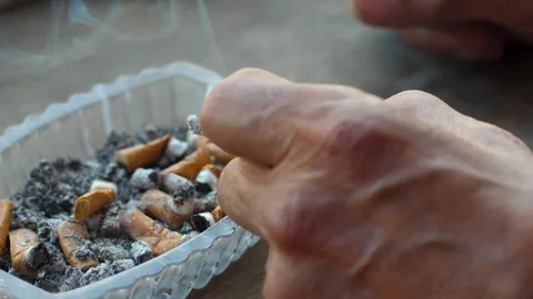 an old man's hand holding a smoking ciga... | Stock Video | Pond5