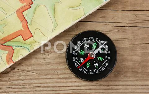Old map and compass on a wooden board Stock Image #12159266