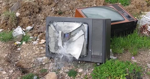 Old retro TV broken by a rock at a junky... | Stock Video | Pond5