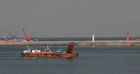 An old rusty barge floats on a bay in th... | Stock Video | Pond5