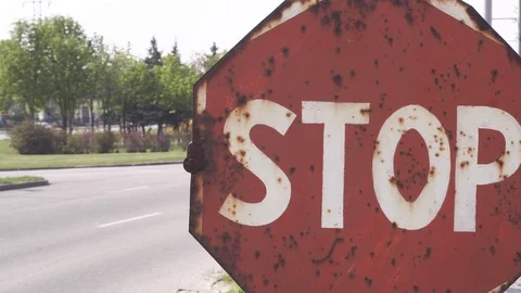 Old rusty "STOP" sign on the background ... | Stock Video | Pond5