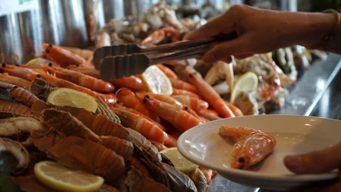 old seafood buffet line hand taking poac... | Stock Video | Pond5