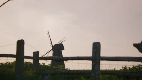 Old static windmill at dusk, pan behind ... | Stock Video | Pond5