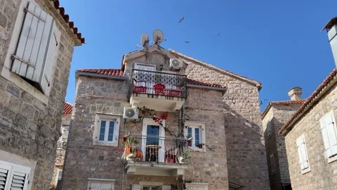 Old stone house with wrought iron balcon... | Stock Video | Pond5