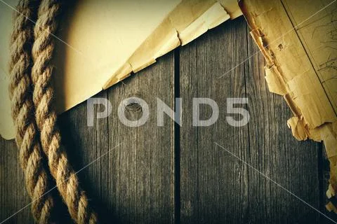 Old torn paper, map and rope Old torn paper, map and rope on wood ...