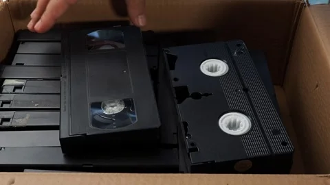Old VHS tapes in a cardboard box. | Stock Video | Pond5