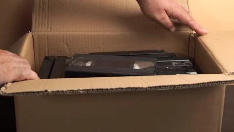 Old VHS tapes in a cardboard box. | Stock Video | Pond5
