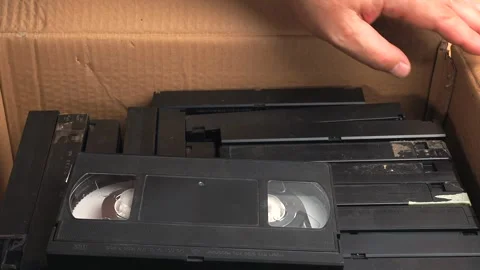 Old VHS tapes in a cardboard box. | Stock Video | Pond5