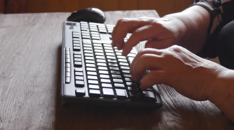 Old woman working on computer at home | Stock Video | Pond5