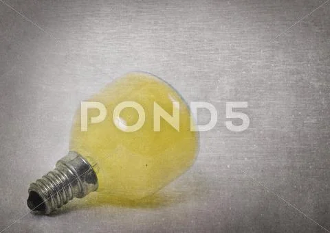 Old yellow lightbulb isolated on a white background: Graphic #60409105