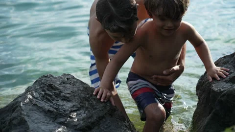 Older brother helping younger siblings t... | Stock Video | Pond5