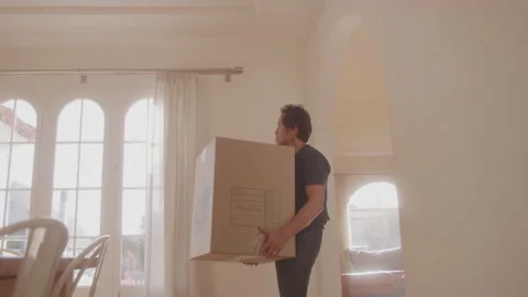 Older Guy Walks Into House With Moving B... | Stock Video | Pond5